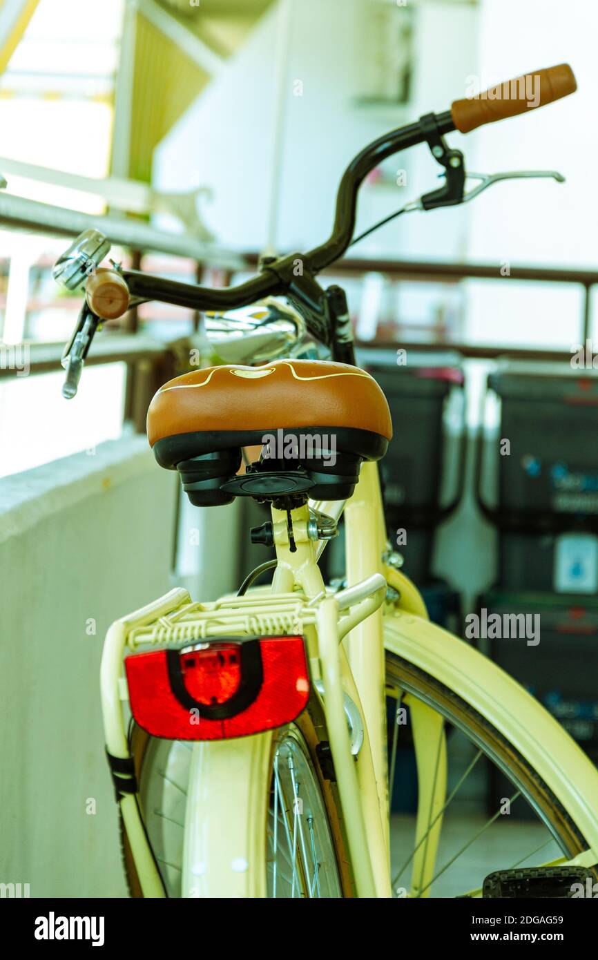 A vertical closeup of a yellow retro bicycle from the back Stock Photo ...