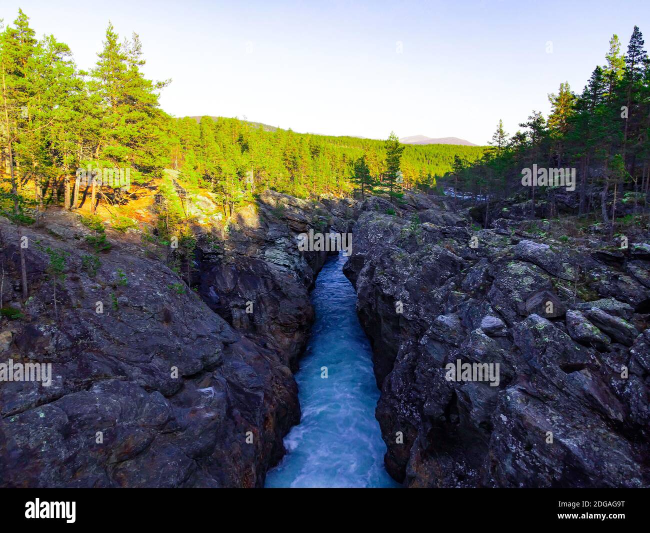 River with clear glacial water carving its way through cliffs in the ...