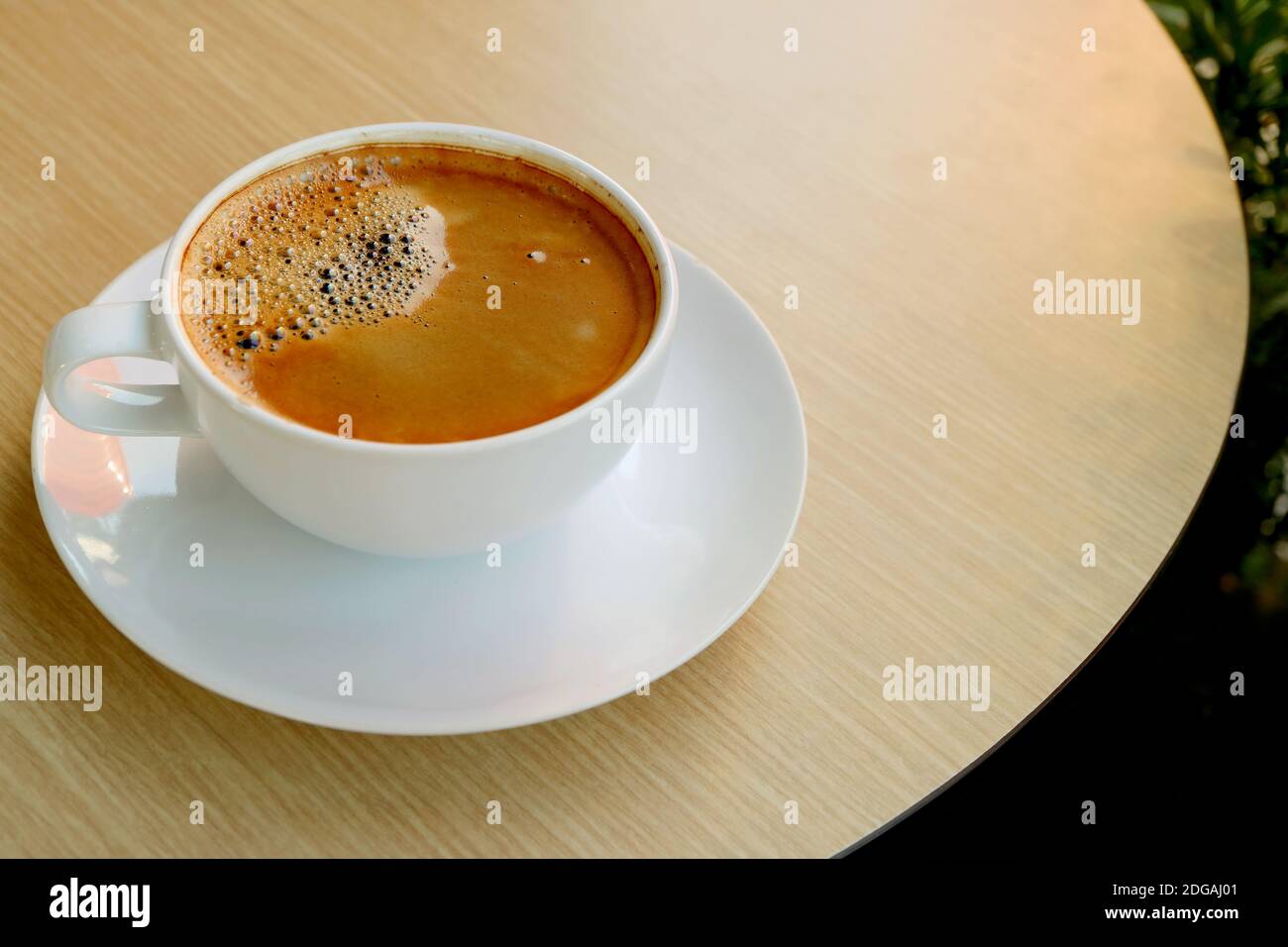 Cup of Hot Coffee with Frothy Surface Isolated on a Round Shaped Wooden ...