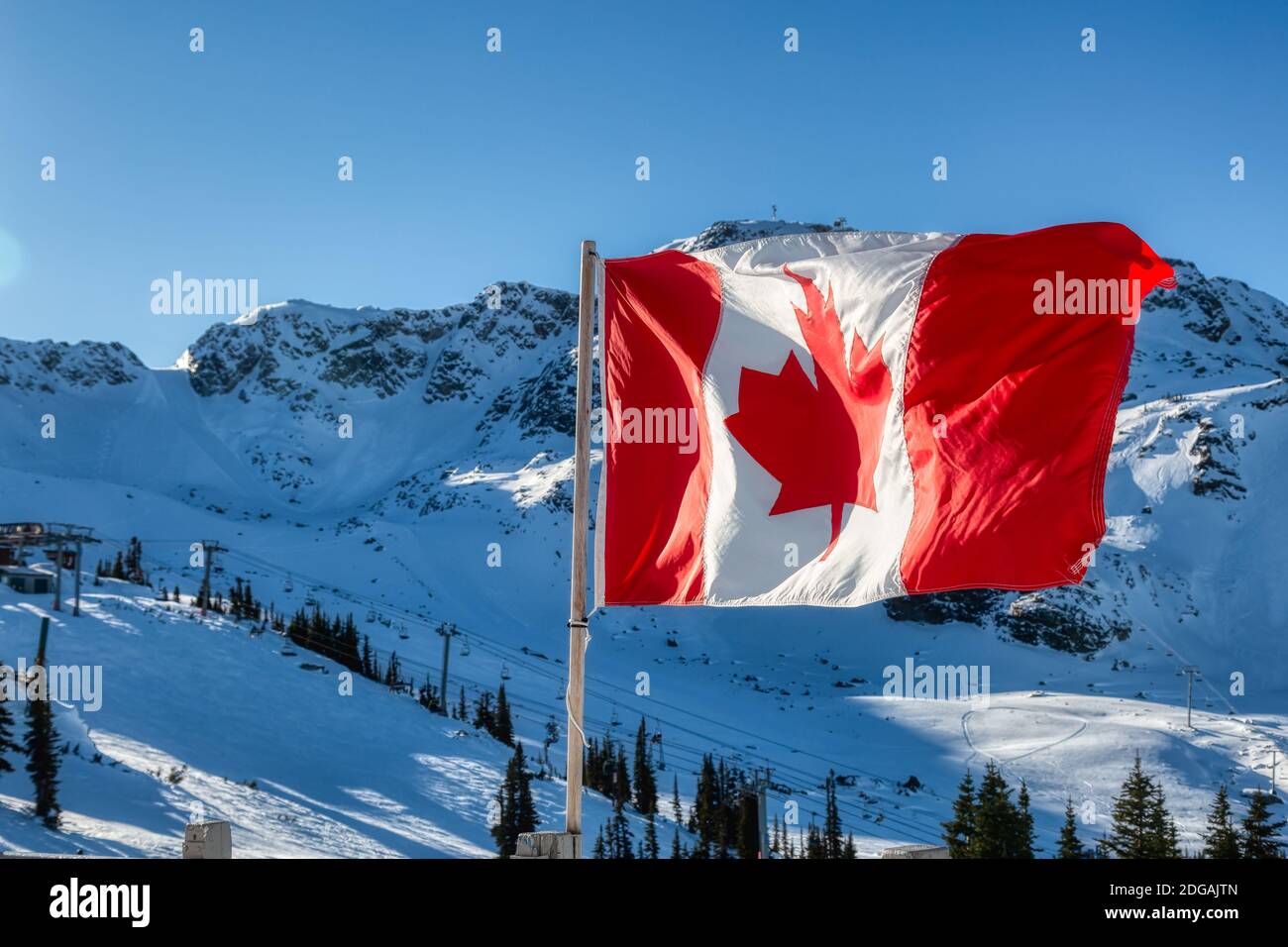 Canadian Flag with a winter mountain landscape Stock Photo - Alamy