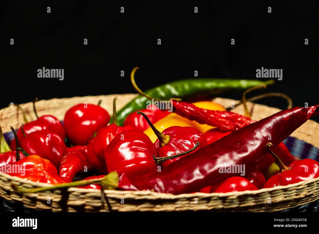 Red chilli peppers on black background Stock Photo - Alamy