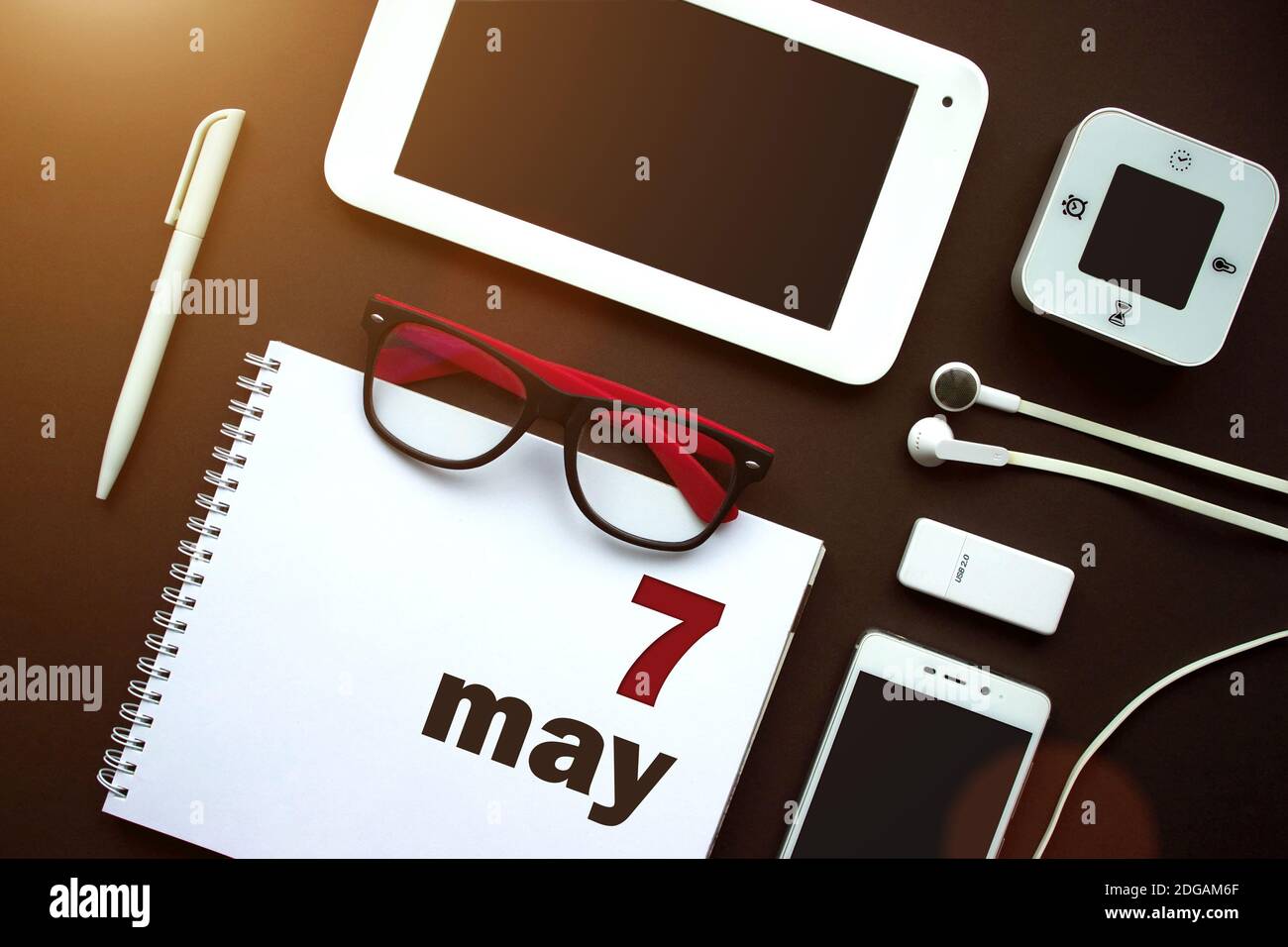 May 7th. Day 7 of month, Calendar date. Office workplace with laptop ...