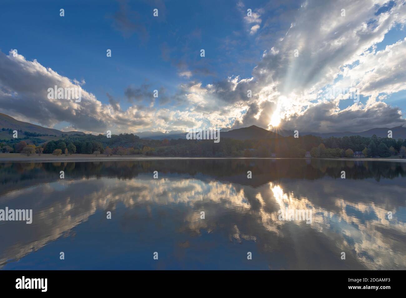 Clouds and rays of the sun reflect on the pond Stock Photo - Alamy