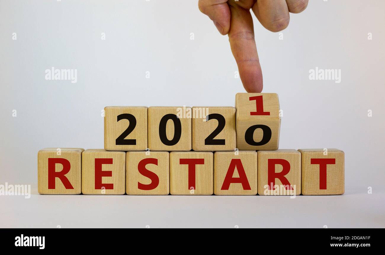 2021 new year restart symbol. Male hand flips wooden cube and changes ...