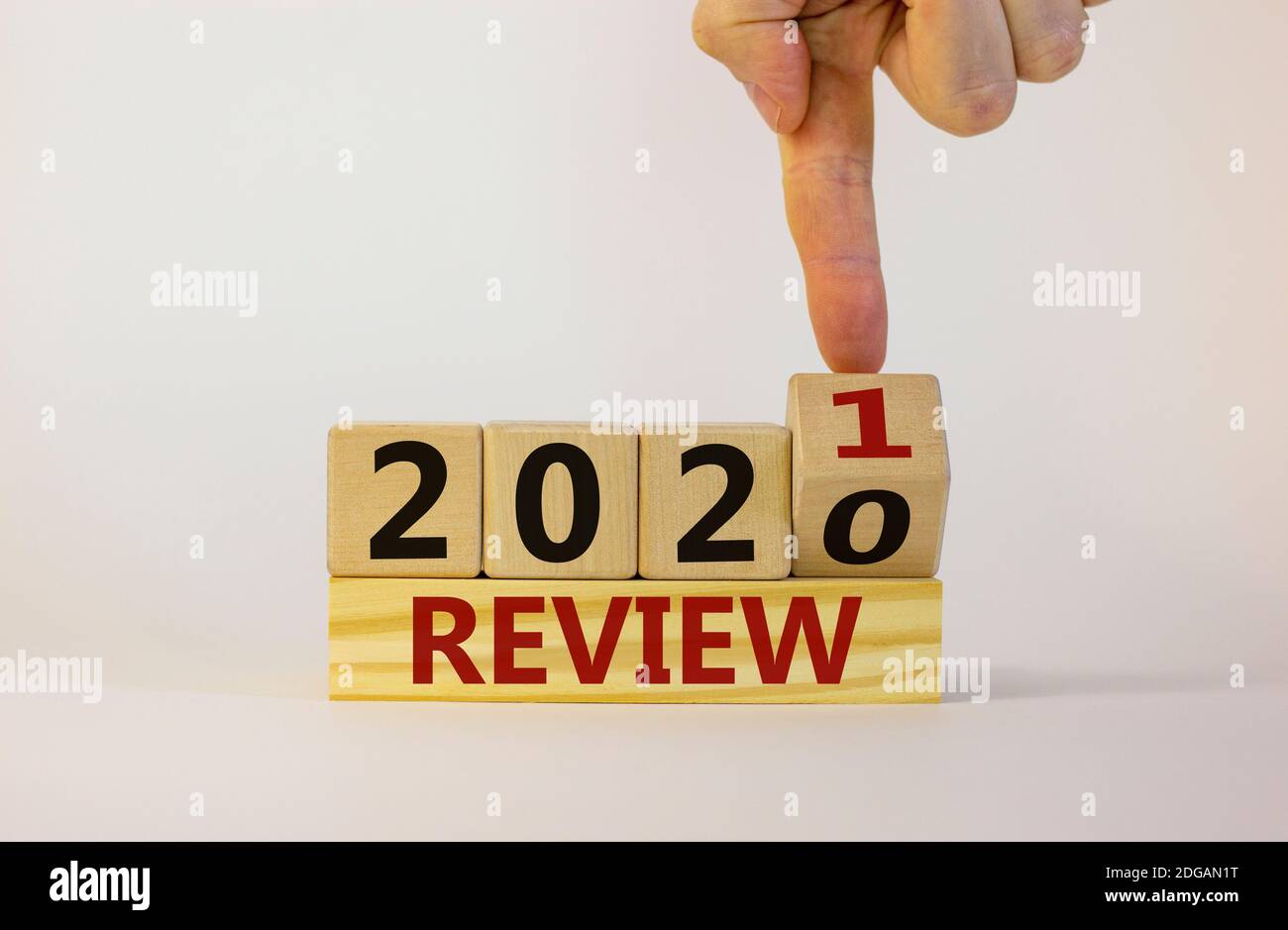 Business concept of new year 2021 review. Male hand flips wooden cube ...
