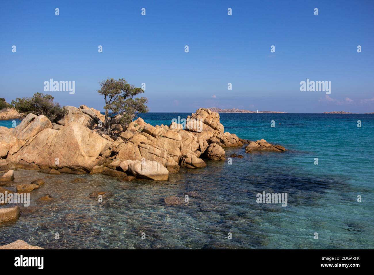 A mound of rocks with bushes at sea Stock Photo - Alamy