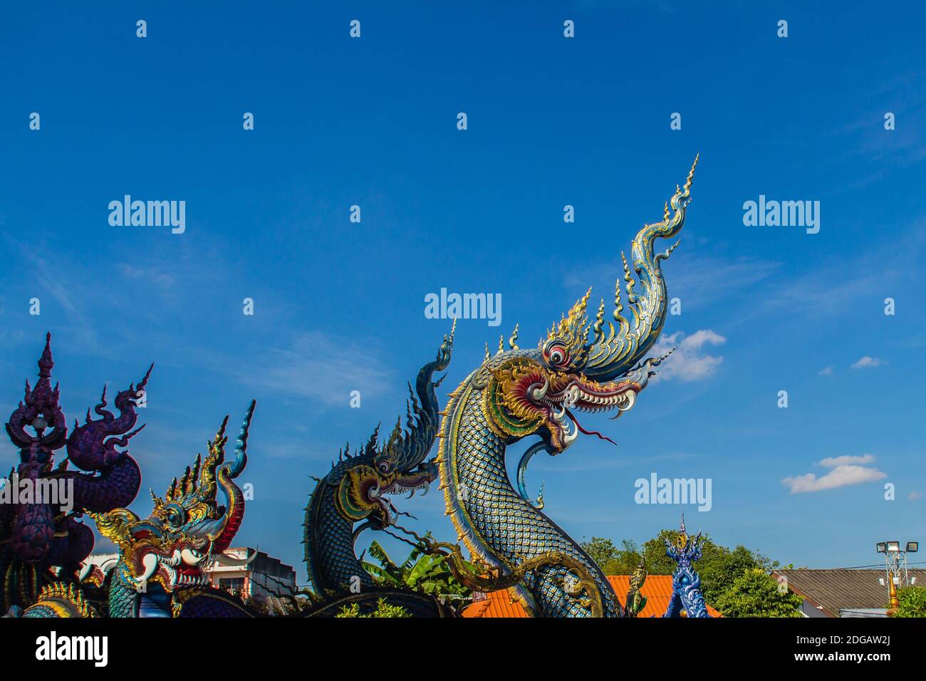 Beautiful blue naga sculpture with blue sky and white cloud on the ...