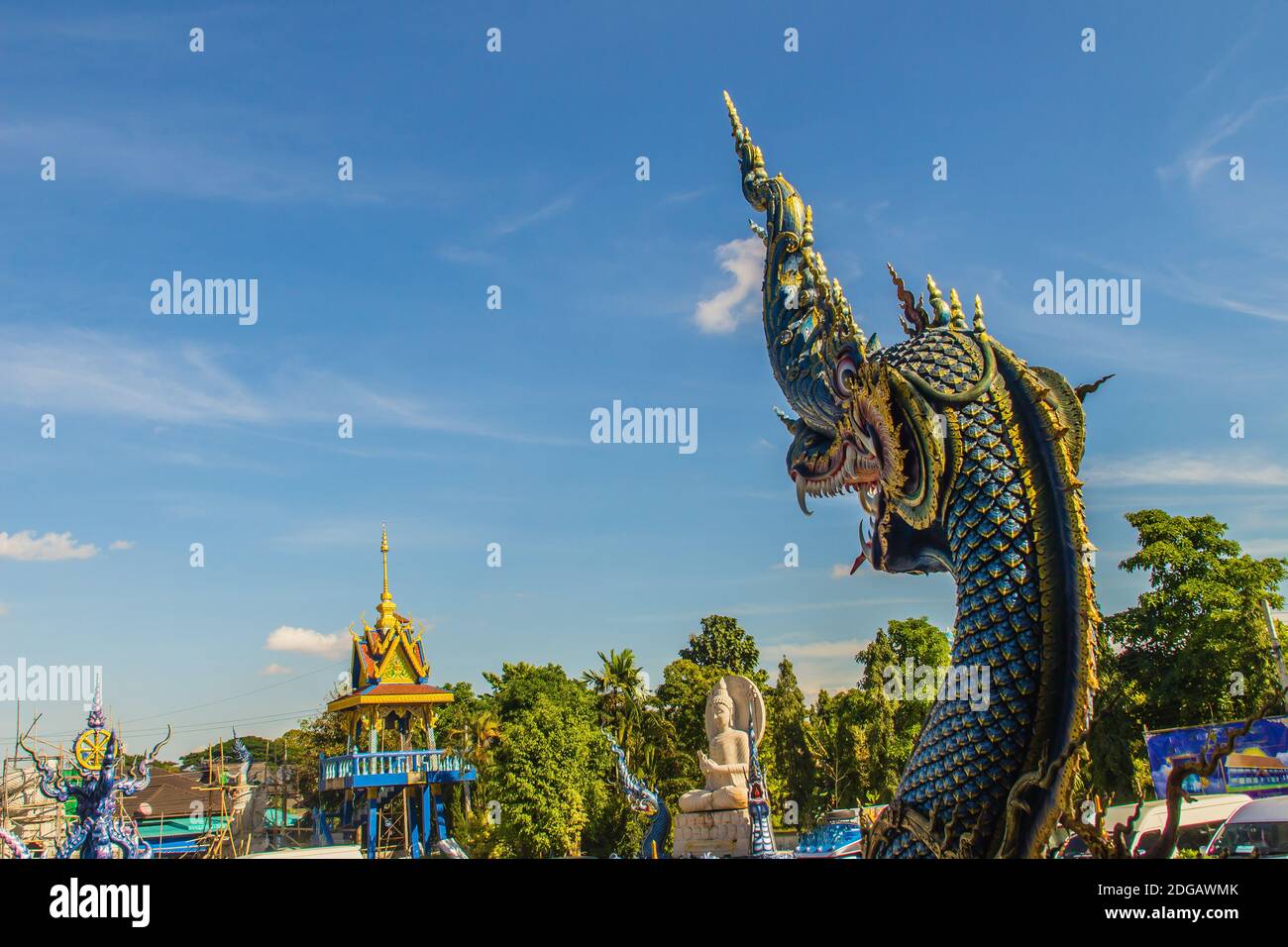 Beautiful blue naga sculpture with blue sky and white cloud on the ...