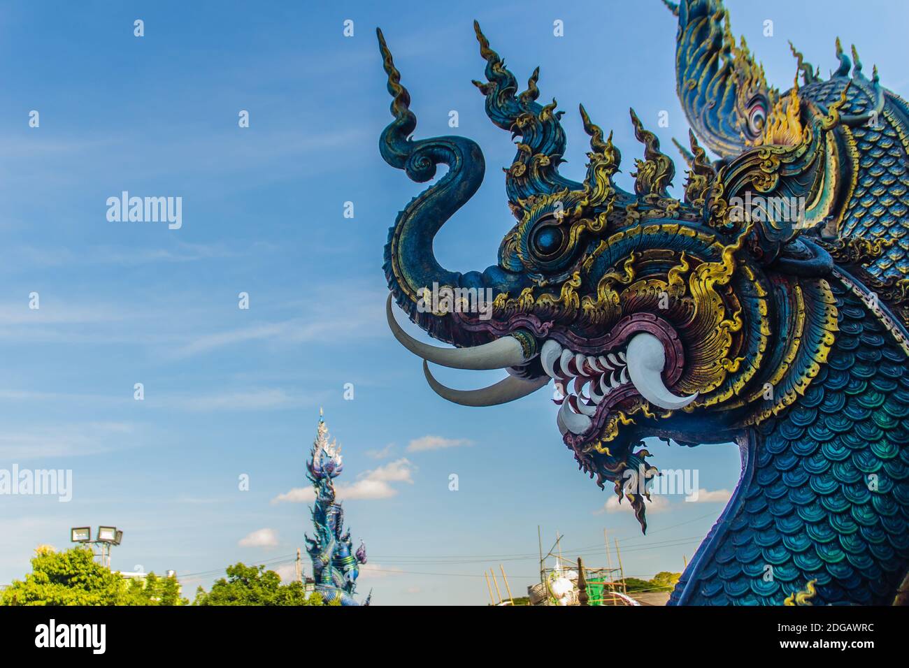 Beautiful blue naga sculpture with blue sky and white cloud on the ...