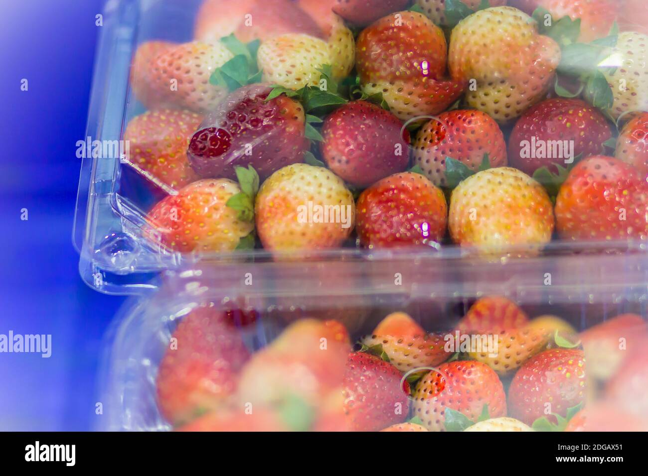 Fresh strawberries in plastic box package at the market. Red ripe ...