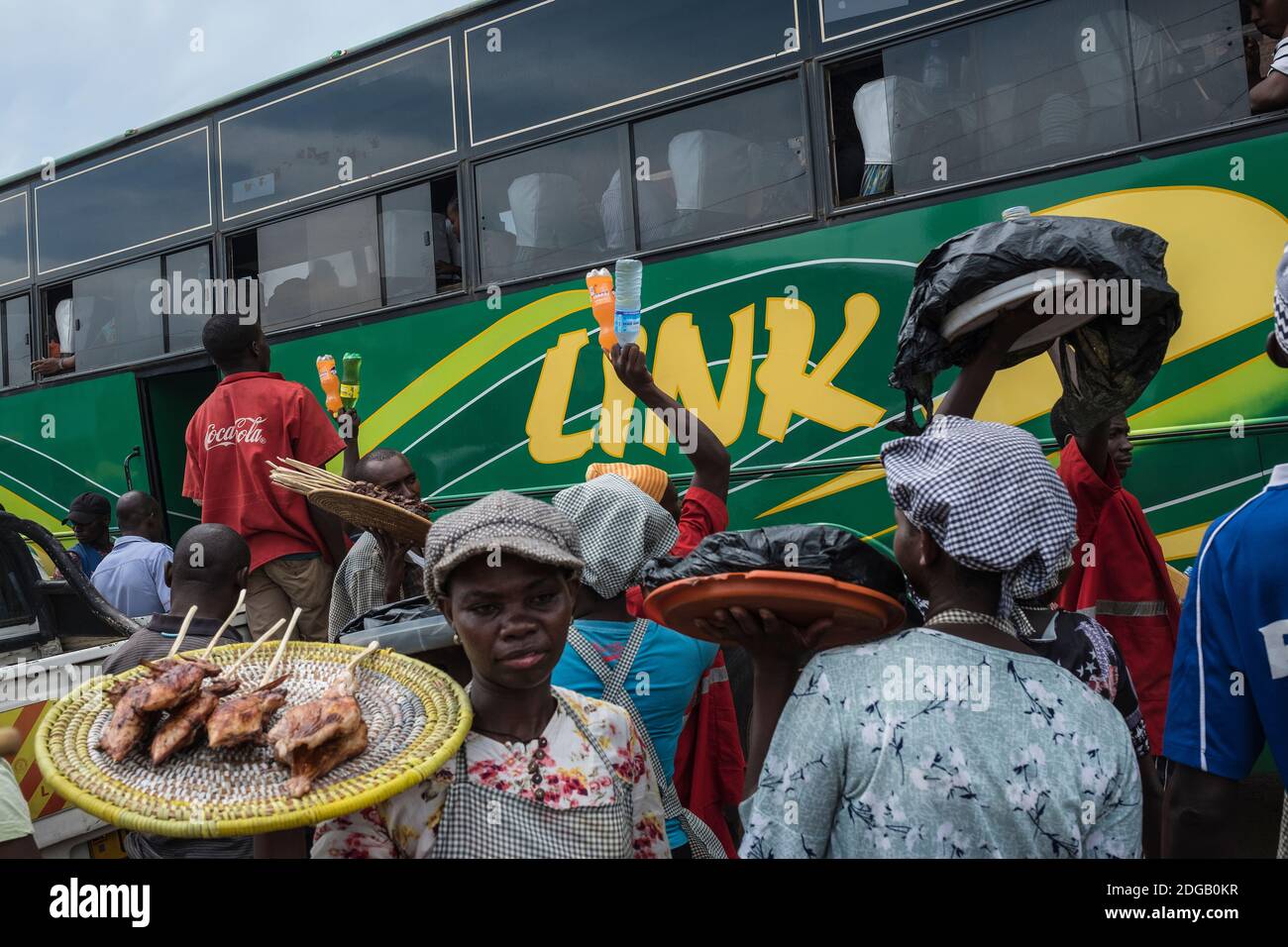 Street sellers sell goods to people on local buses passing through the ...