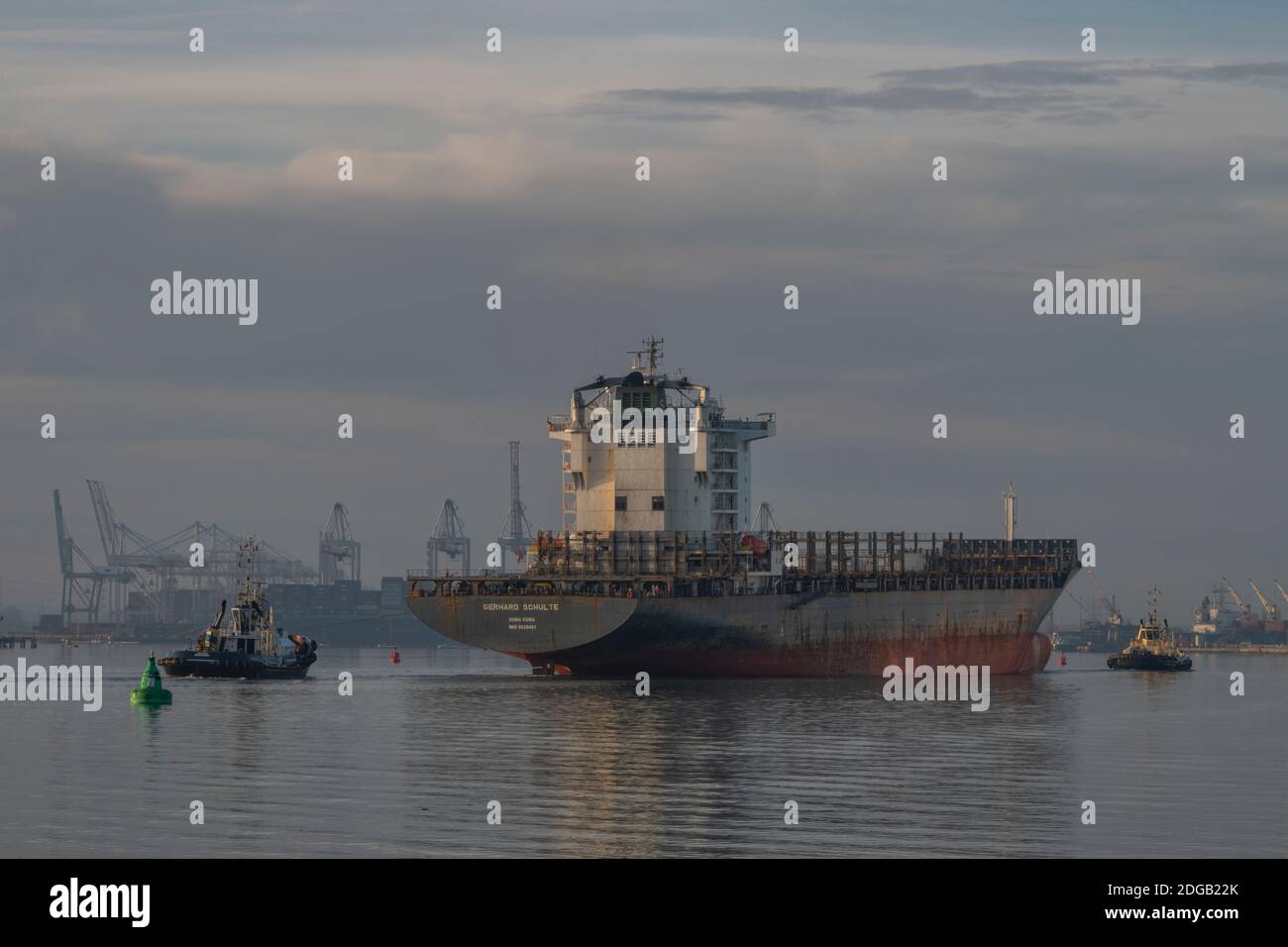 a large container ship empty in the port of southampton docks being ...