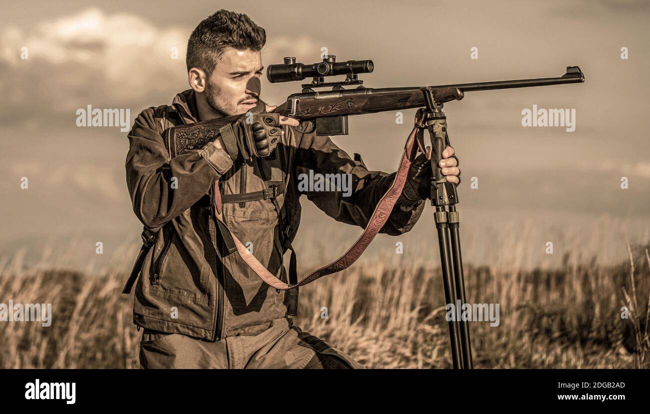 Hunter man. Shooter sighting in the target. Hunting period. Hunter with ...