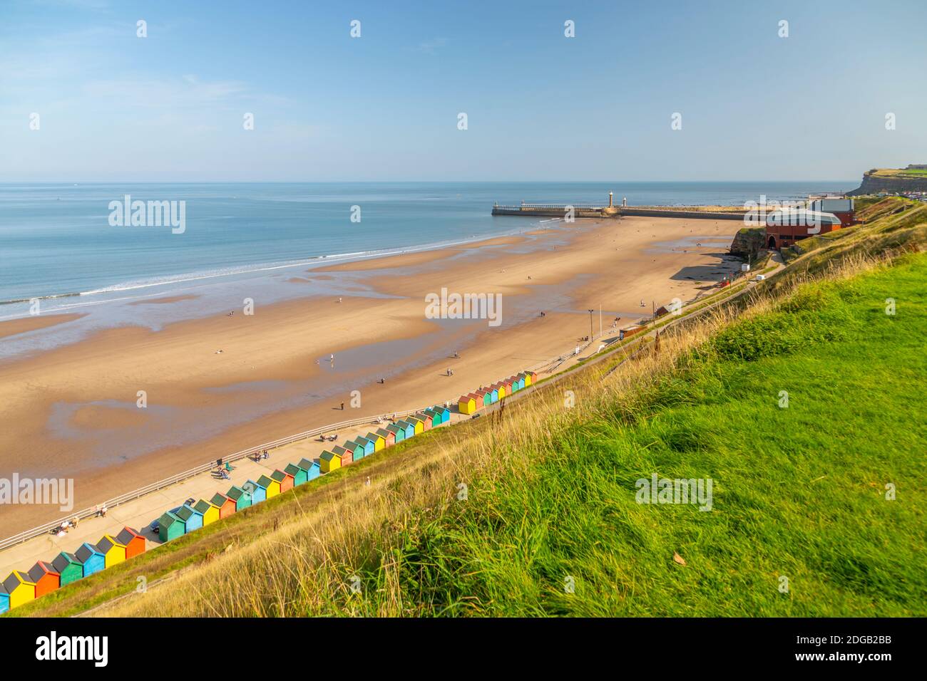 View of colourful beach huts on West Cliff Beach, Whitby, North ...