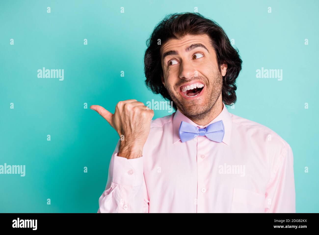 Photo of charming gentle man dressed pink outfit pointing one thumb ...
