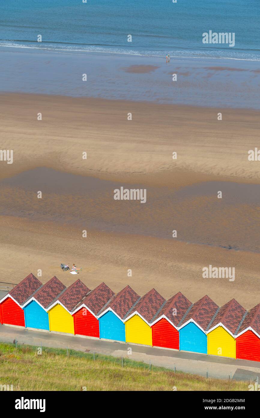 View of colourful beach huts on West Cliff Beach, Whitby, North ...