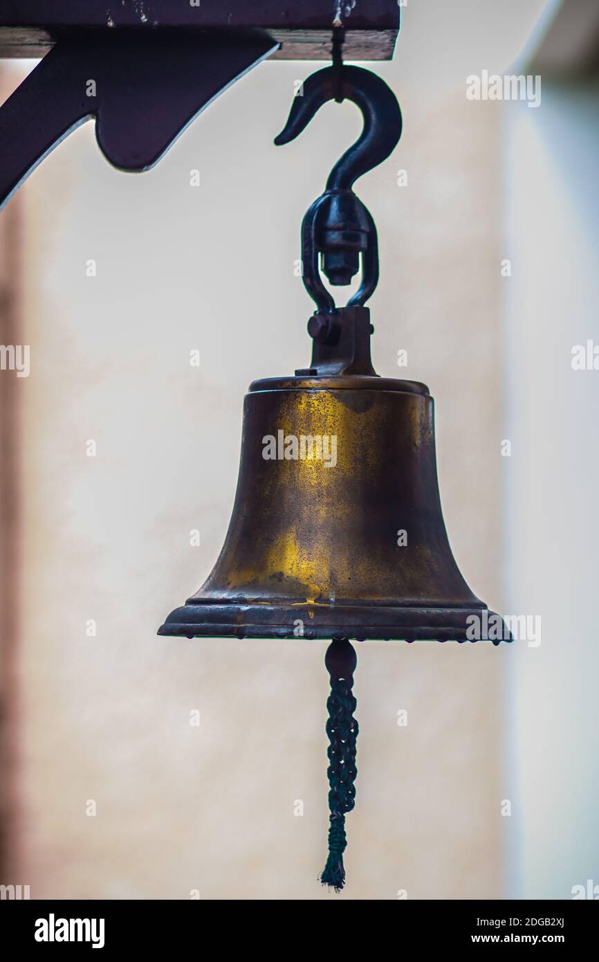 Old naval brass bell. Vintage metal ship's bell with a rope. Nautical ...