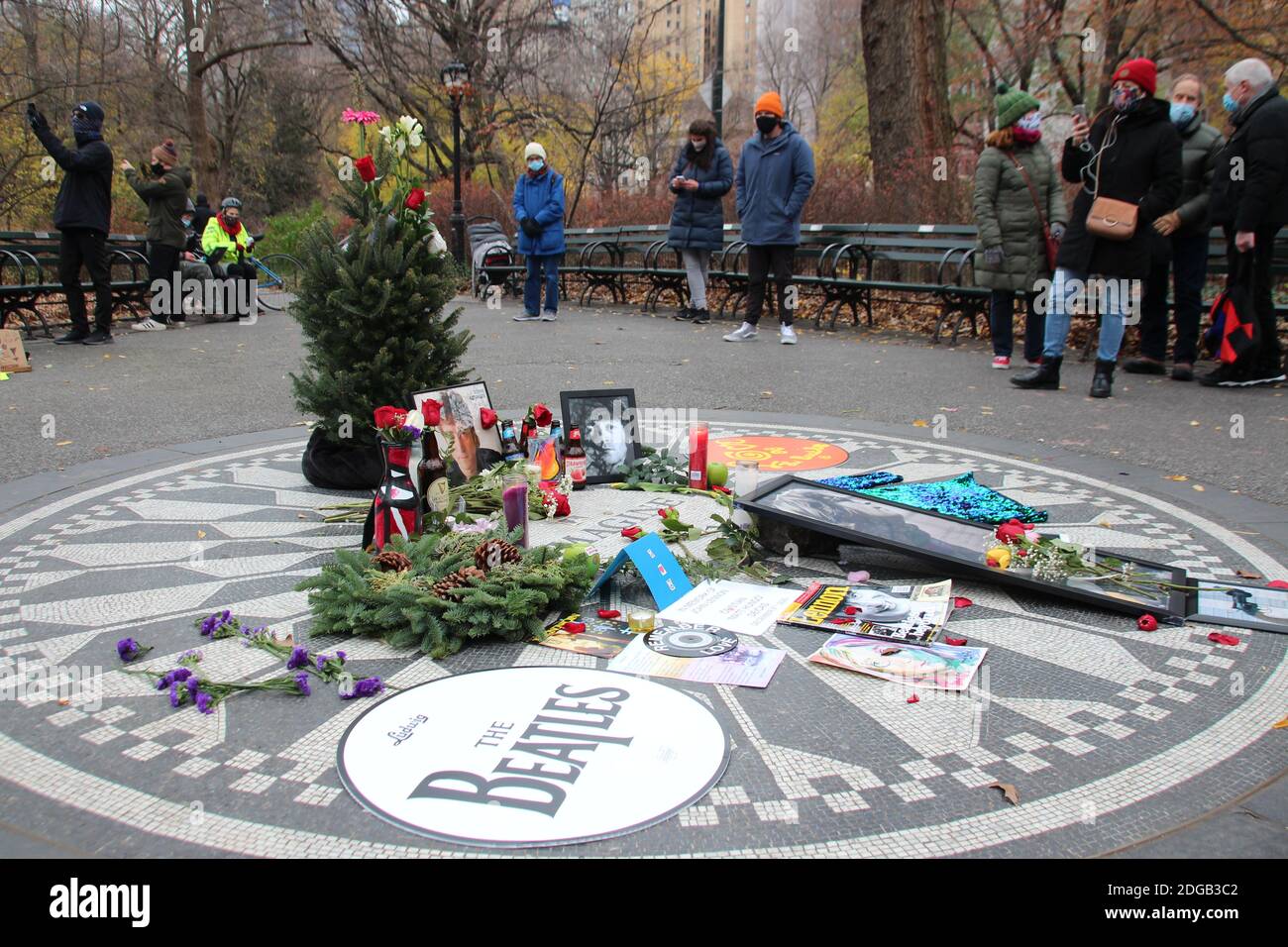 New York, USA. 08th Dec, 2020. Photos, flowers and candles are on ...