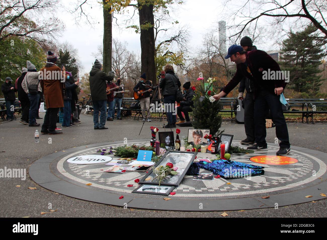 New York, USA. 08th Dec, 2020. Photos, flowers and candles are on ...