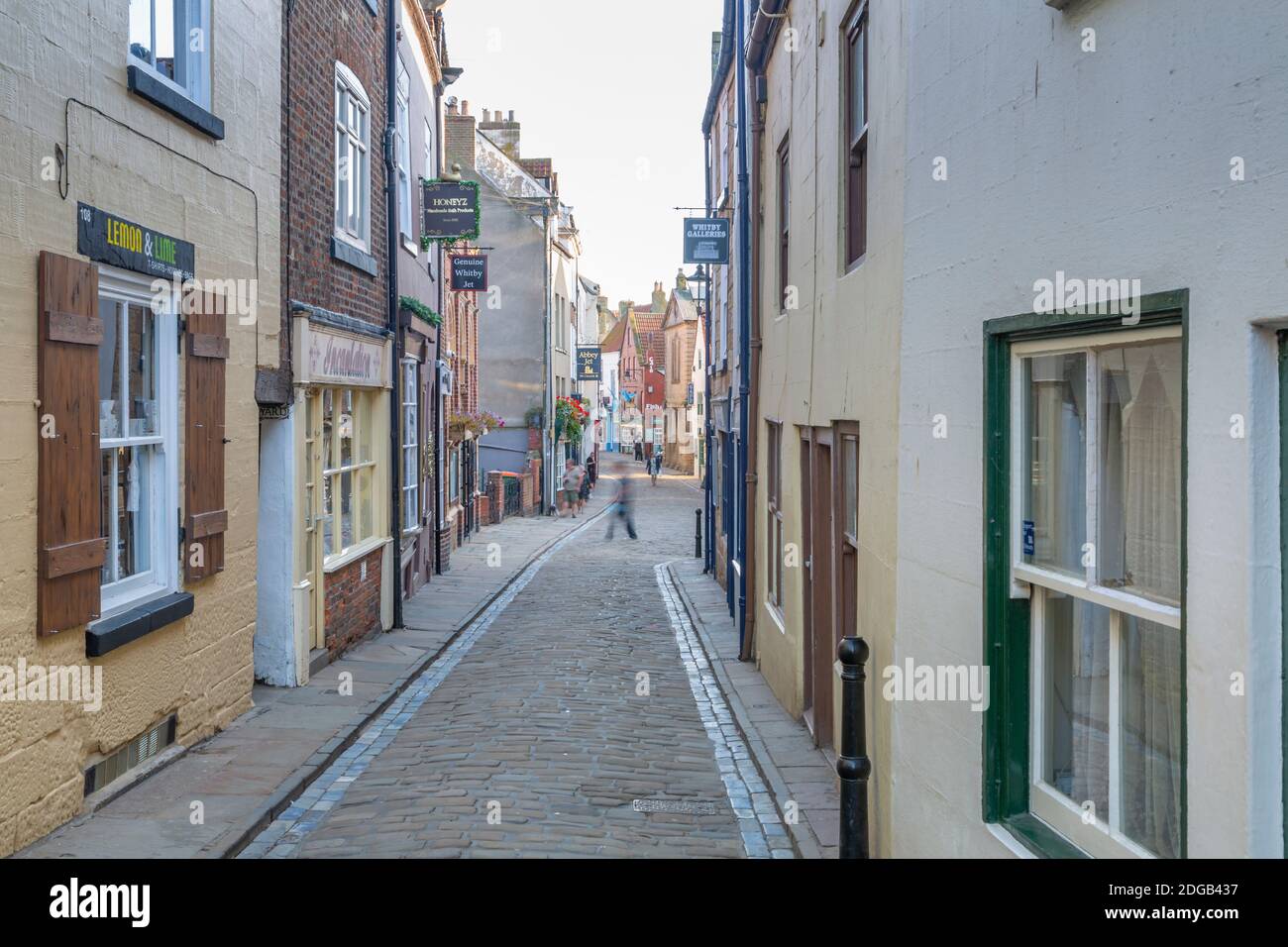 View of shops on traditional cobbled street in historic town centre ...