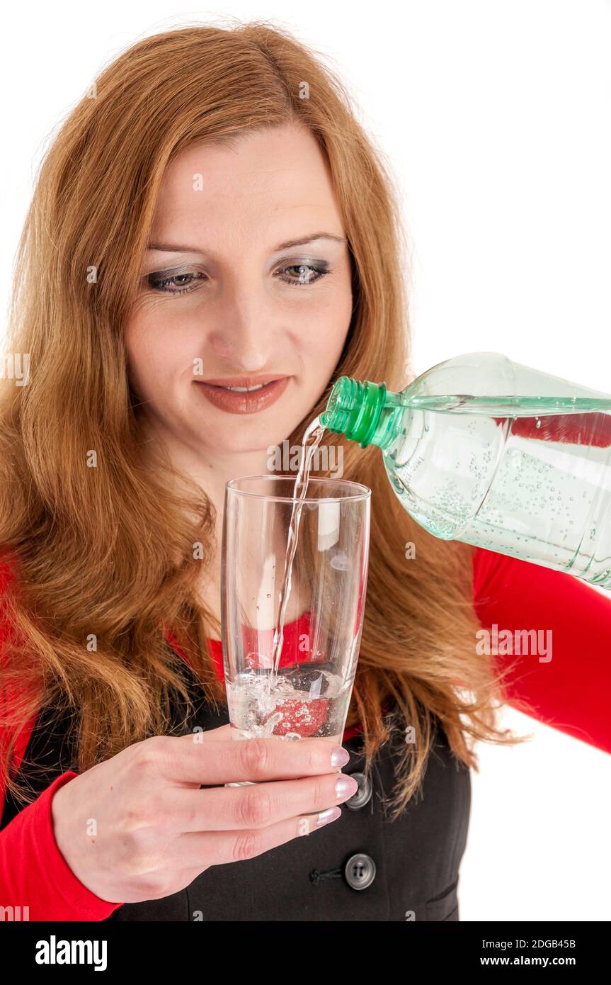 Frontal torso view of a young blonde woman pouring herself mineral ...