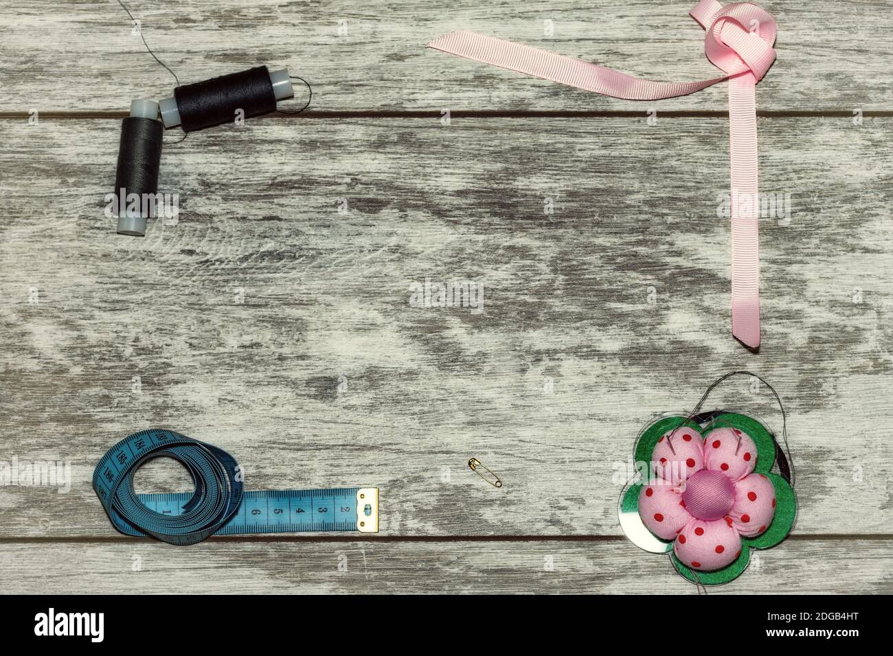 Buttons, ribbon , thread and needles for sewing Stock Photo - Alamy