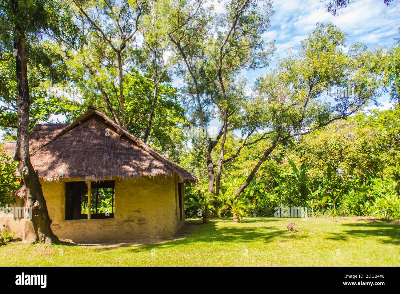 Earthen house under shade of trees. An earth house, also known as earth ...