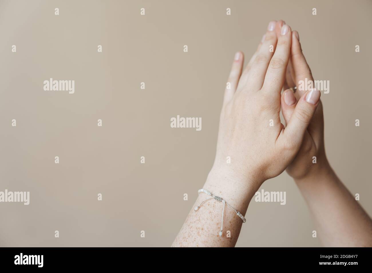 Woman's hands begging isolated over background Stock Photo - Alamy