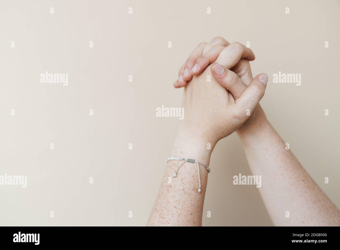 Woman's hands begging isolated over background Stock Photo - Alamy