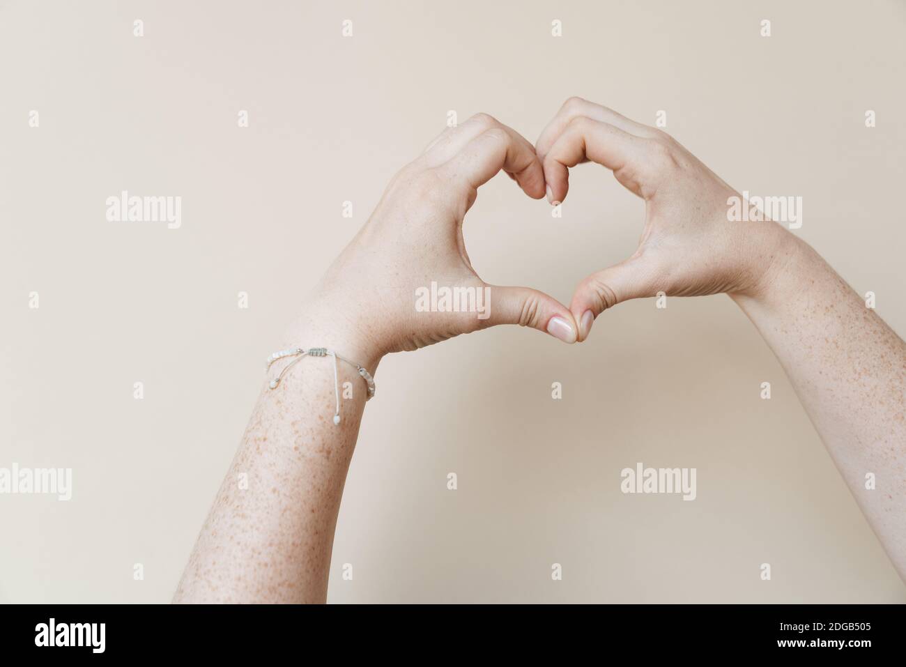 Woman's hands showing heart gesture isolated over background Stock ...