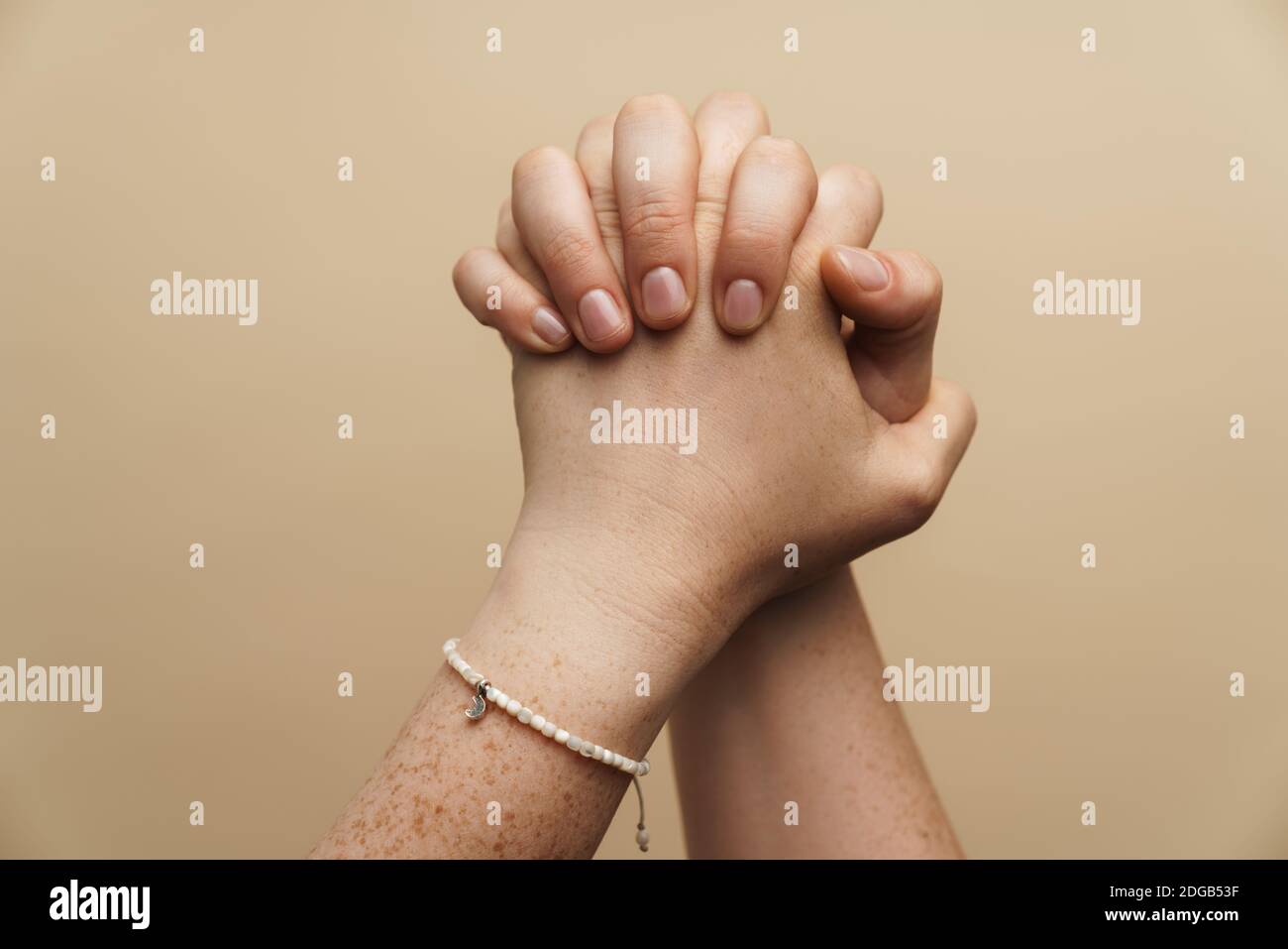 Woman's hands begging isolated over background Stock Photo - Alamy