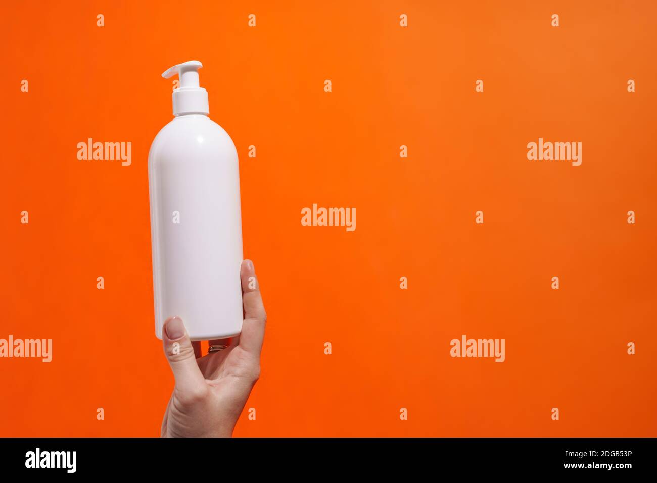 Woman's hand showing lotion blank bottle isolated Stock Photo - Alamy