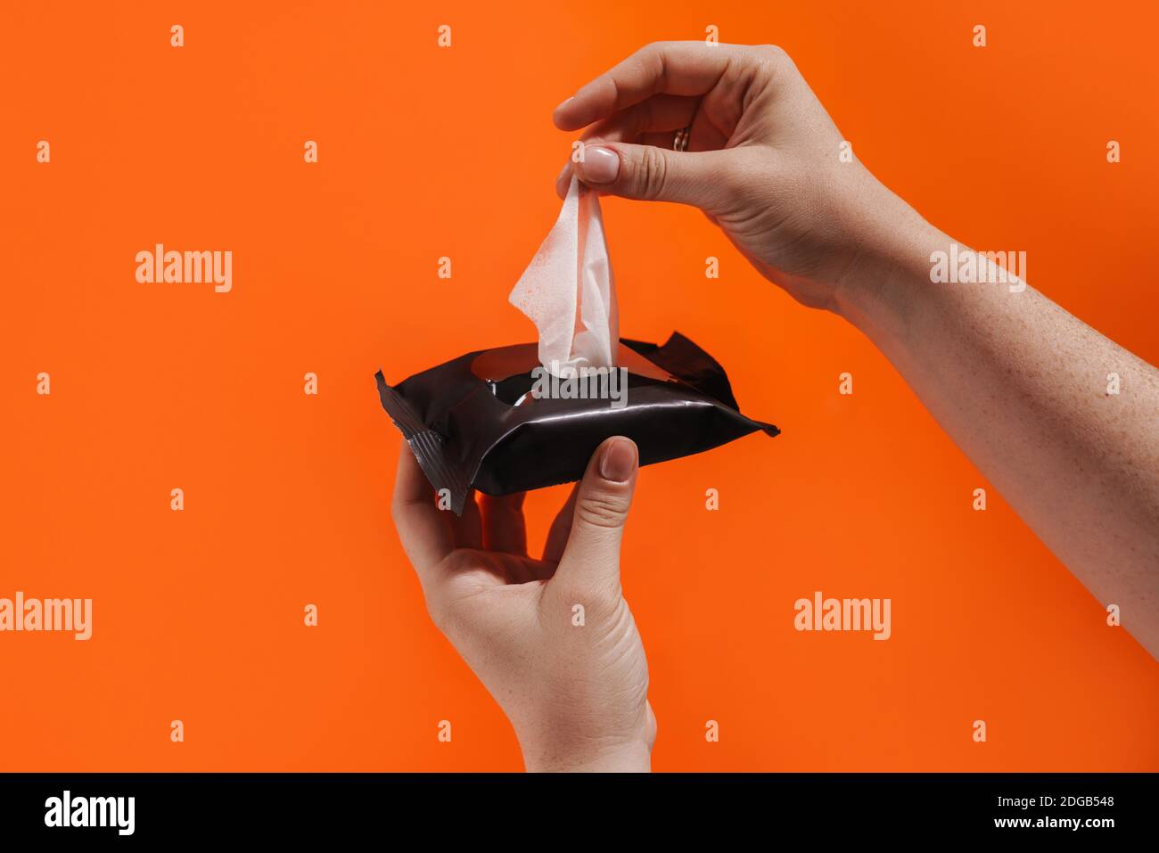 Woman's hands using wet wipes isolated over background Stock Photo - Alamy