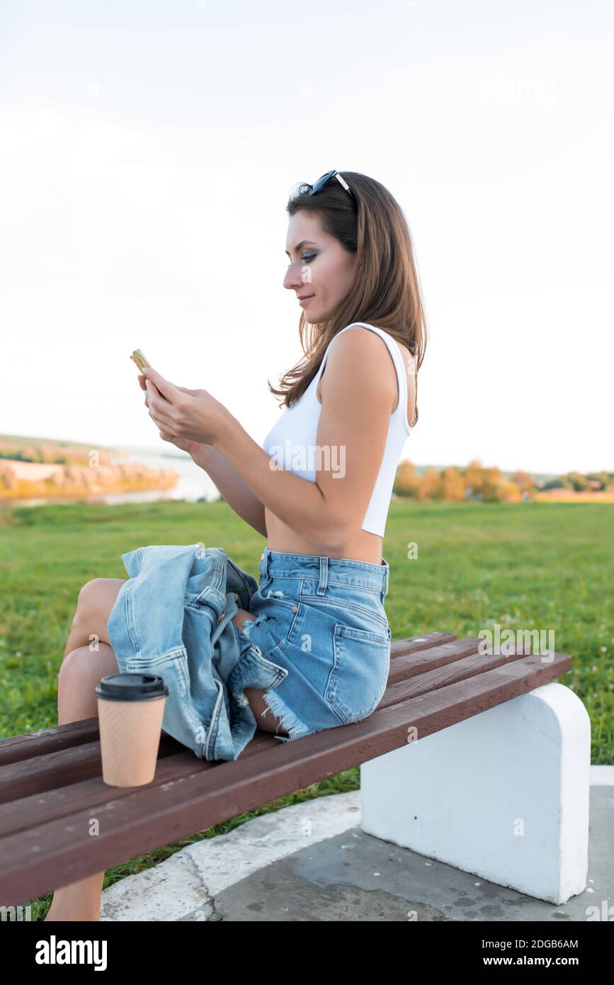 People sit on bench texting hi-res stock photography and images - Alamy