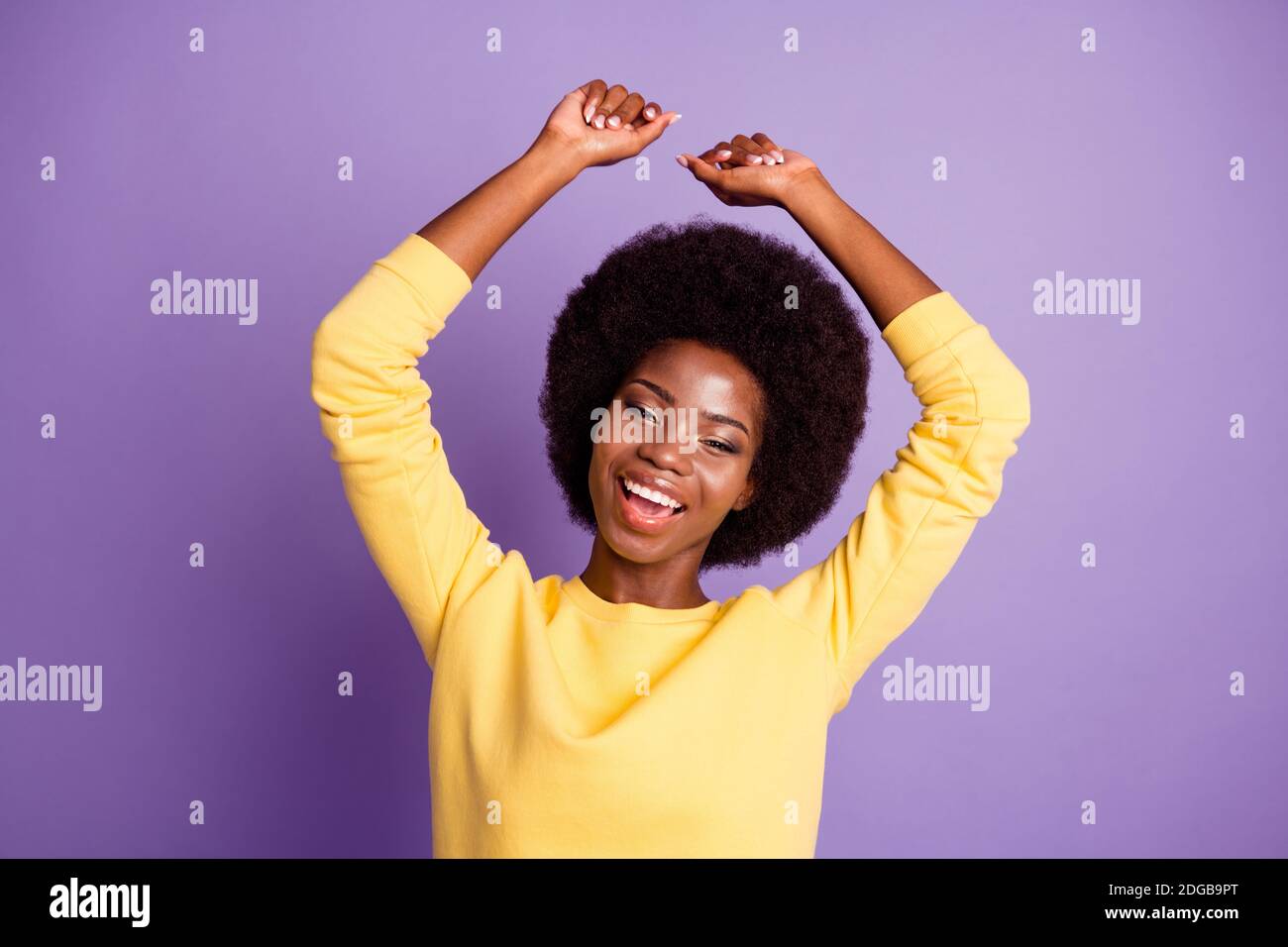 Photo of lovely young lady raise hands dance open mouth wear yellow ...