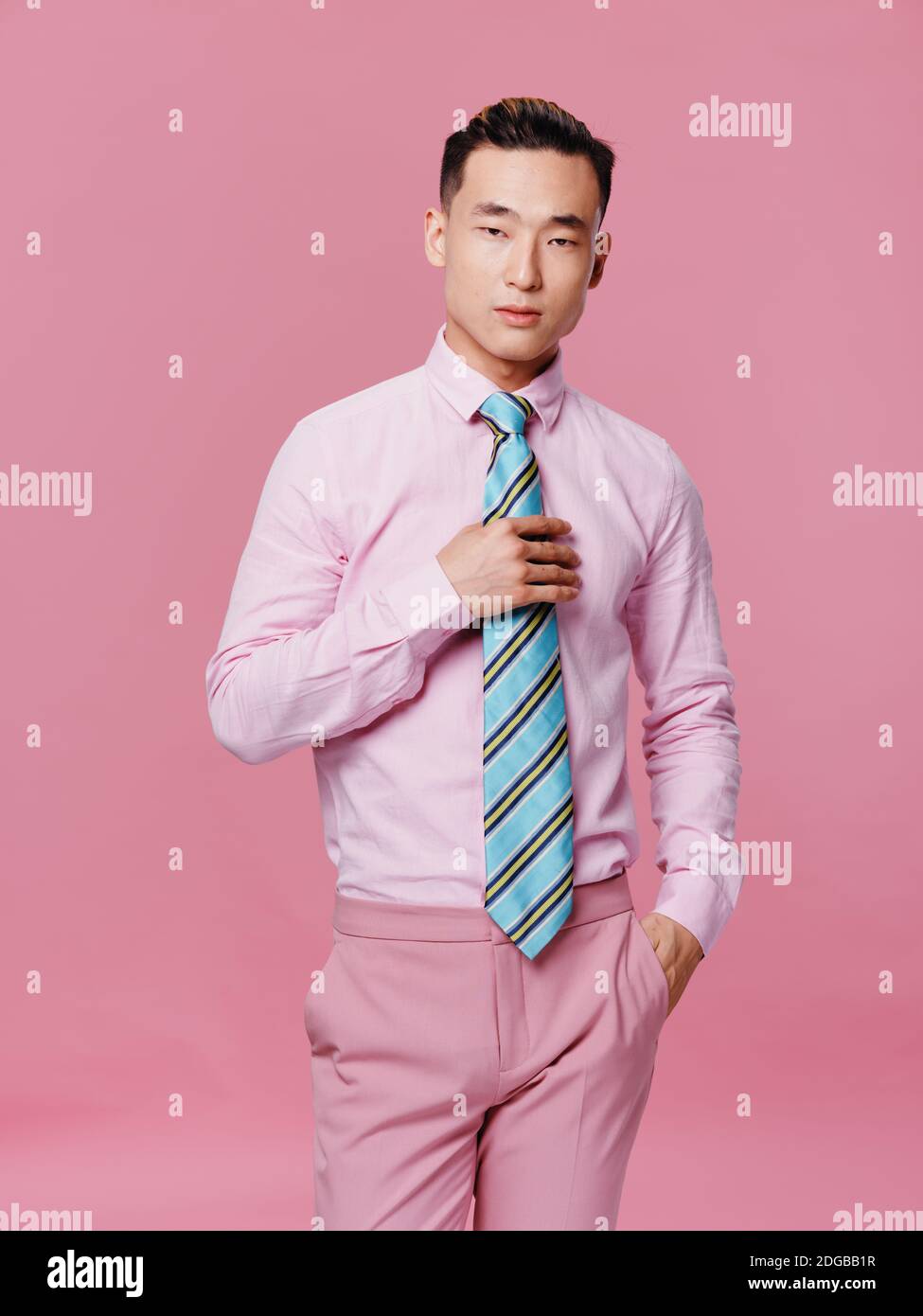 Cute man of asian appearance pink shirt striped tie pink background ...