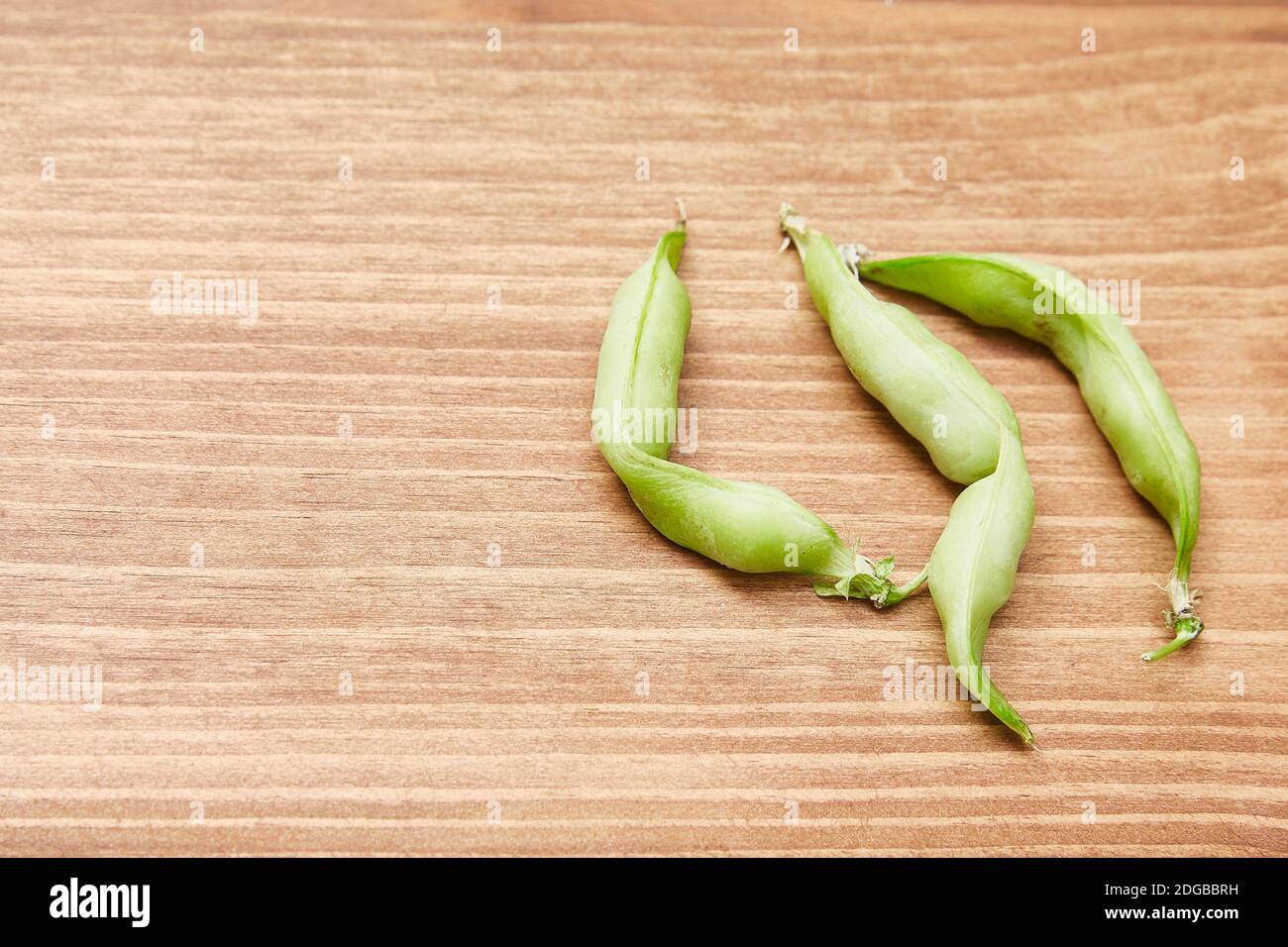 Ugly organic home grown pea on wooden background. Trendy ugly food ...