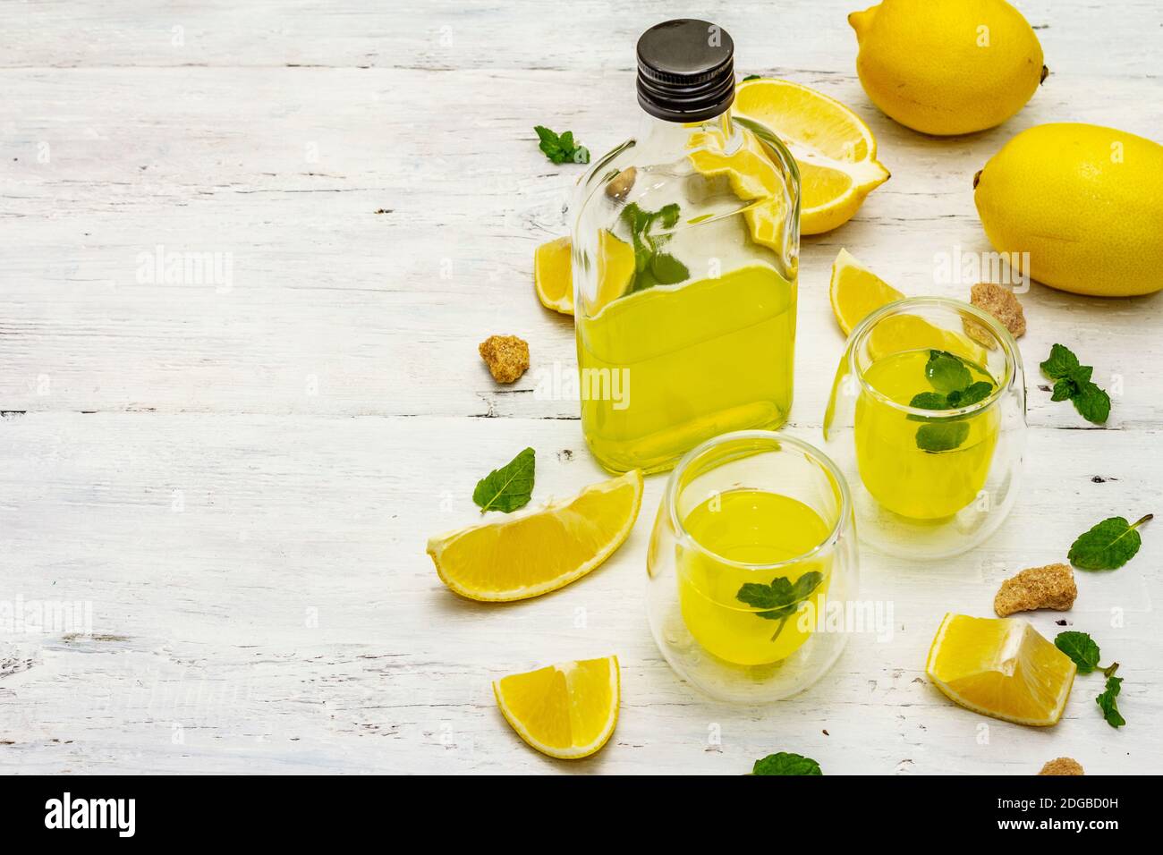 Traditional Italian digestif: liqueur Limoncello with lemons and ...