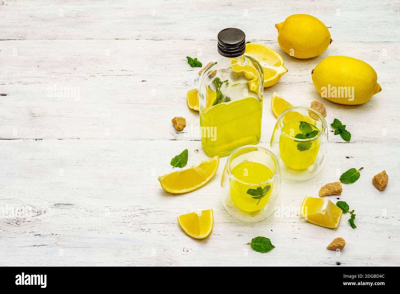 Traditional Italian digestif: liqueur Limoncello with lemons and ...