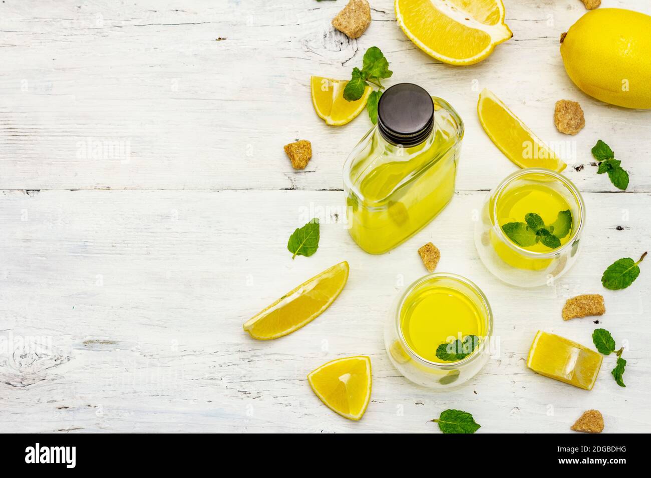 Traditional Italian digestif: liqueur Limoncello with lemons and ...