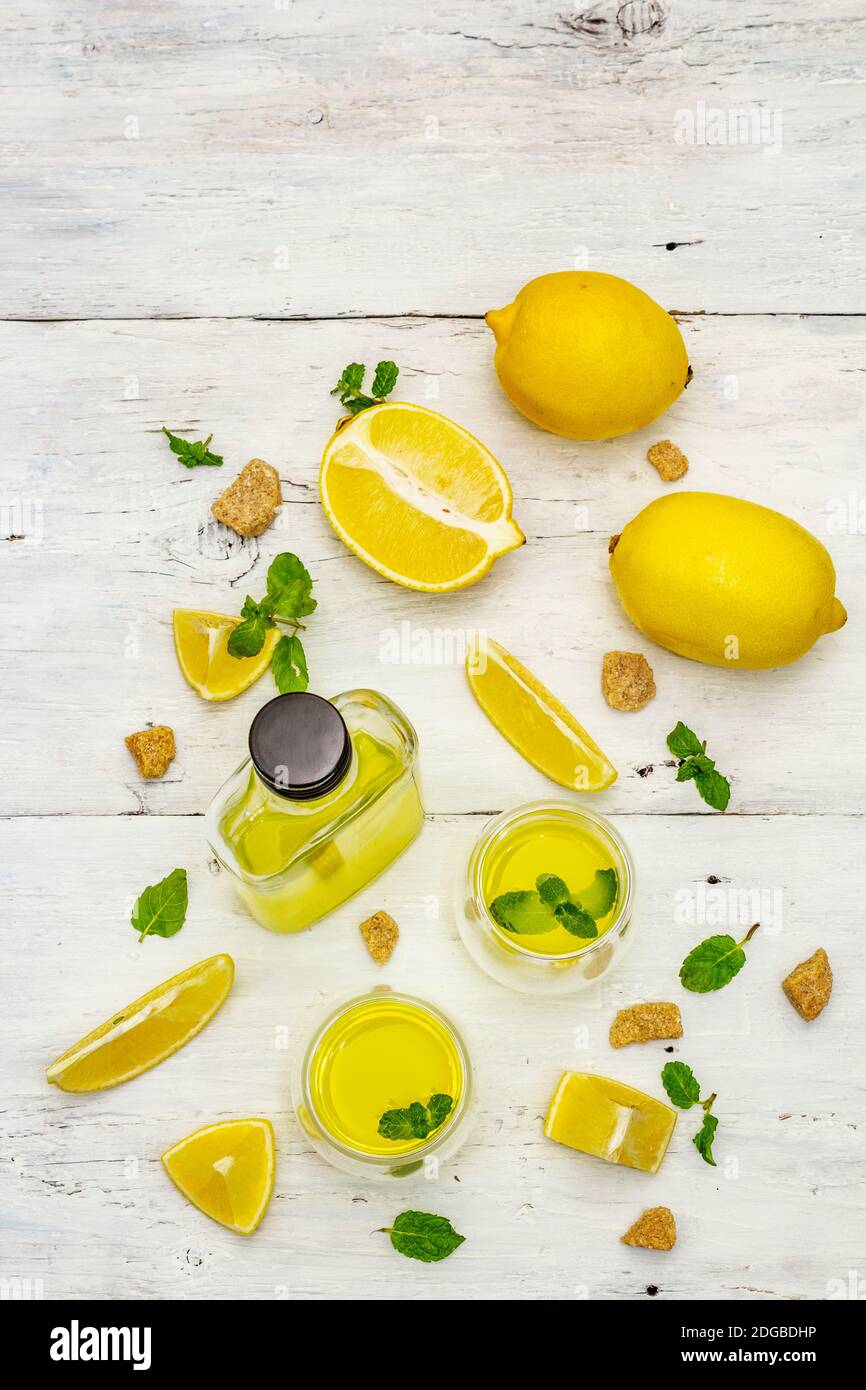 Traditional Italian digestif: liqueur Limoncello with lemons and ...