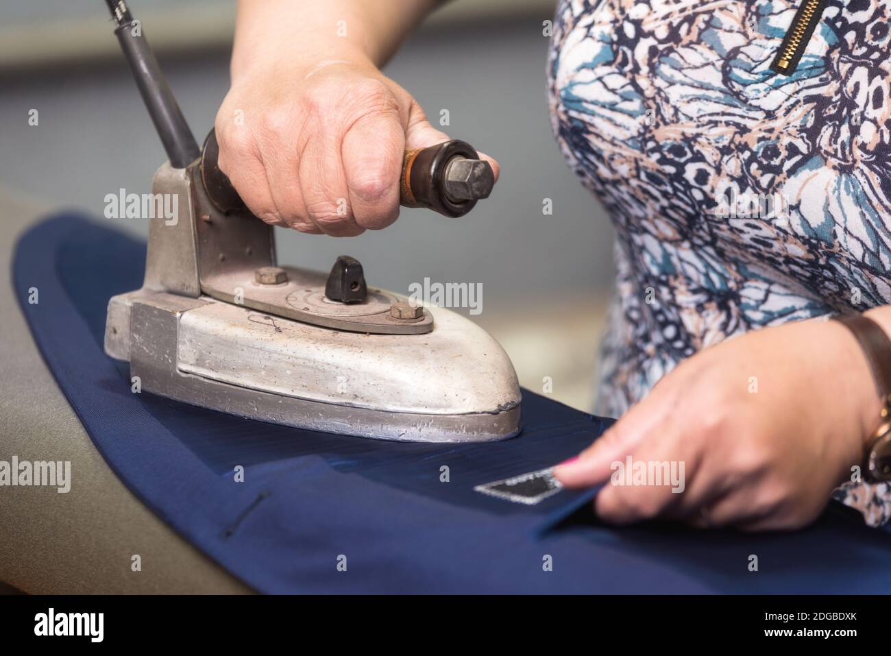 Seamstress ironing suit in tailor shop Stock Photo - Alamy