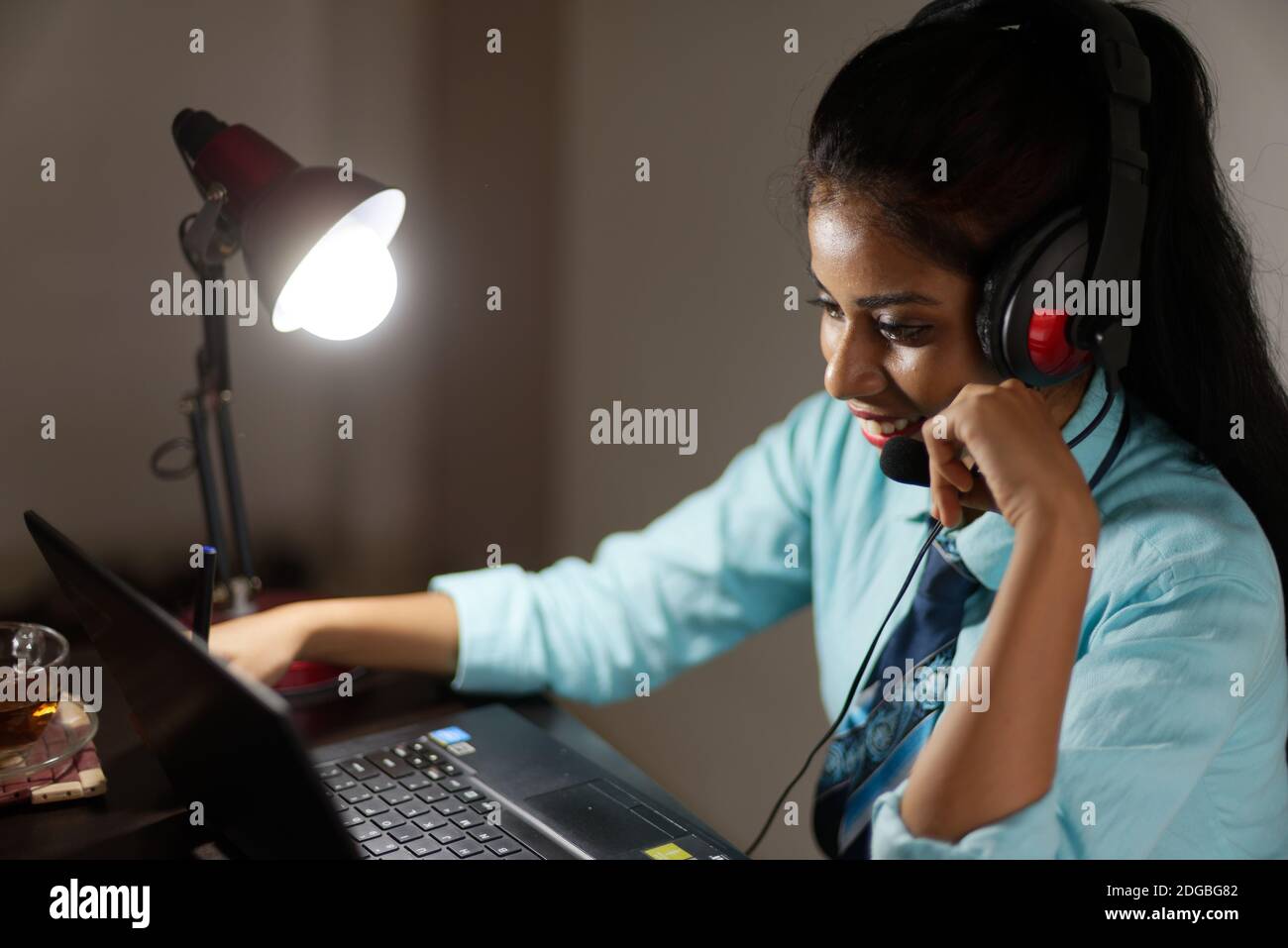 An Indian Bengali brunette young woman/telecaller in office wear is ...
