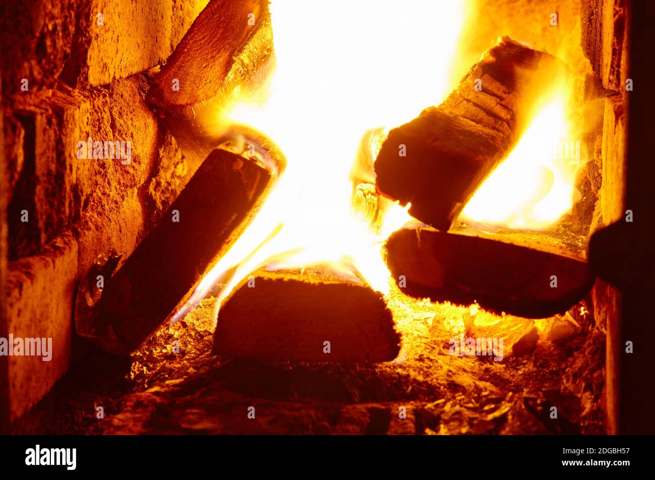 Crest of flame on burning wood in fireplace. Close-up of fire in hot ...