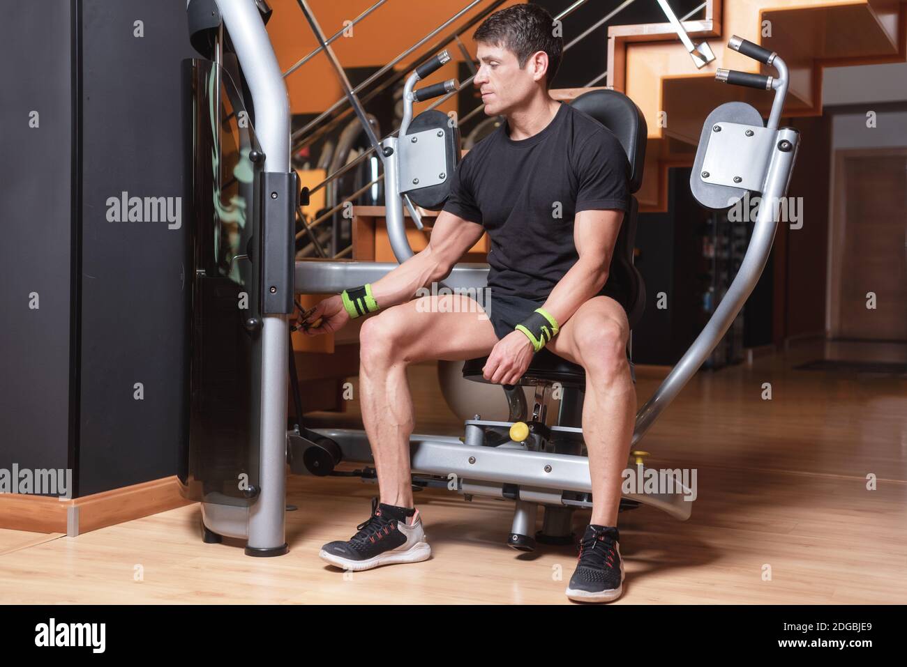 Handsome muscular man ready to work out at press chest machine. Chest ...