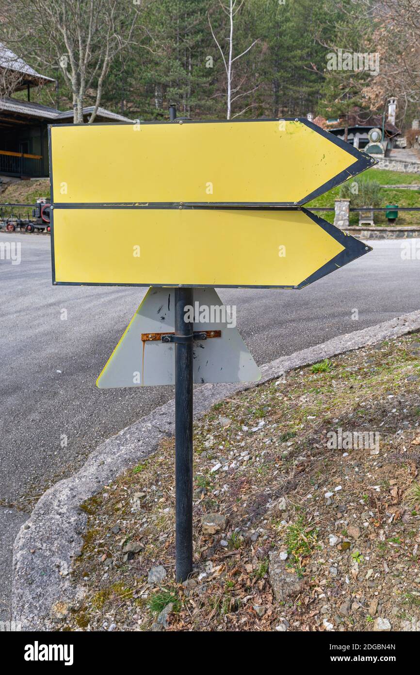 Two Directional Arrows at Traffic Sign Pole Stock Photo - Alamy
