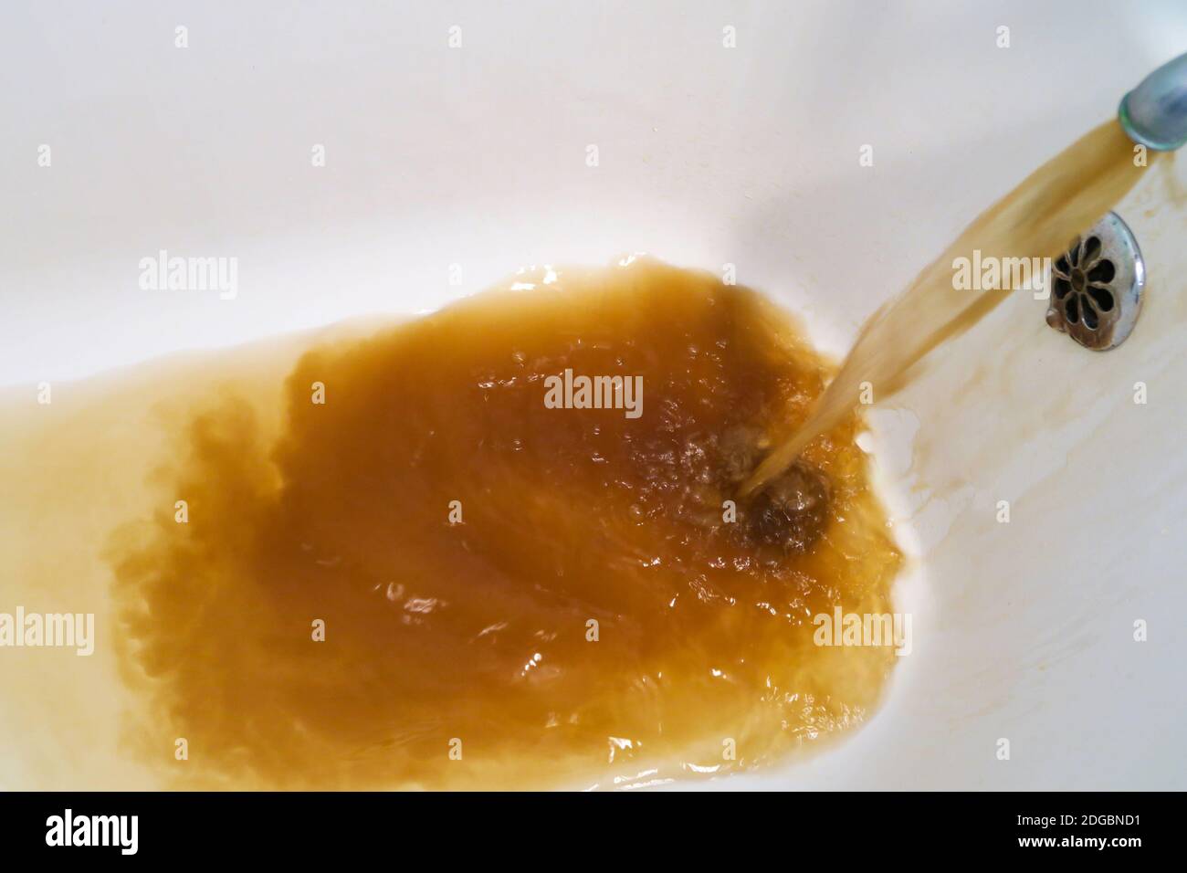 Dirty Tap Water Pouring from Bath tub Faucet Stock Photo - Alamy