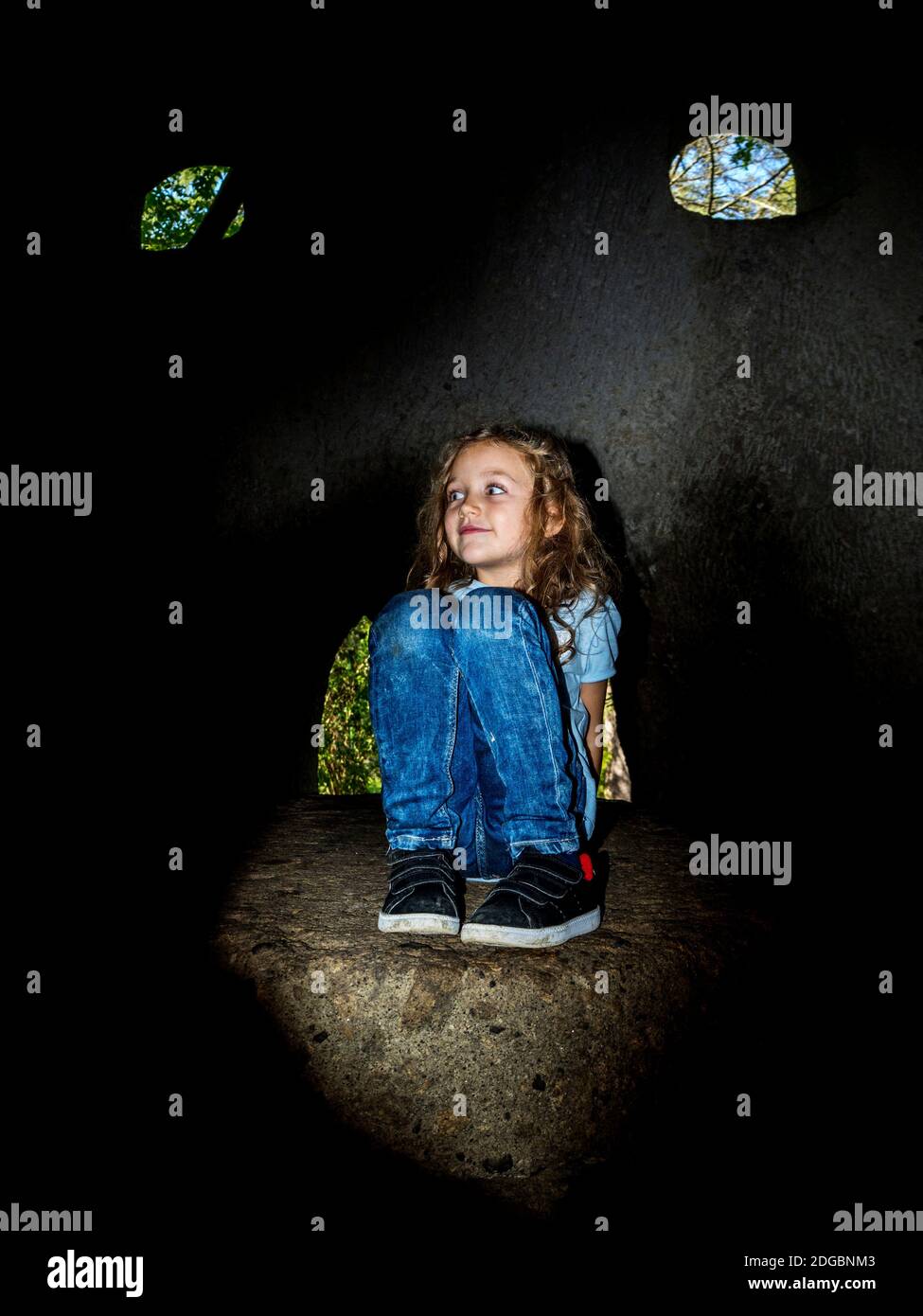 Smiling girl sitting in a den Stock Photo - Alamy
