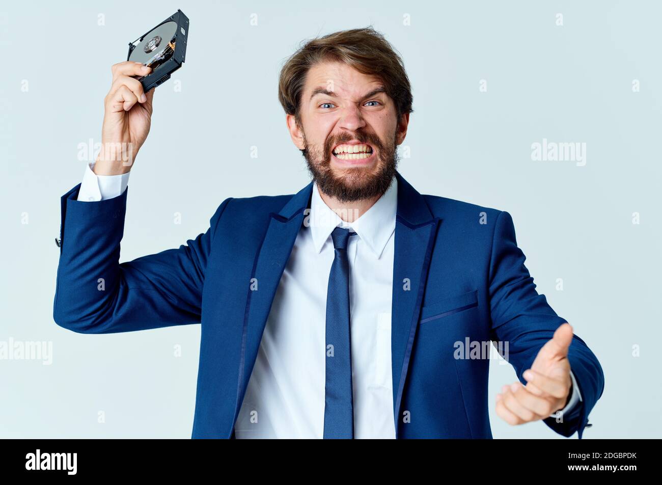 aggressive man with hard drive in hands emotions irritability light ...