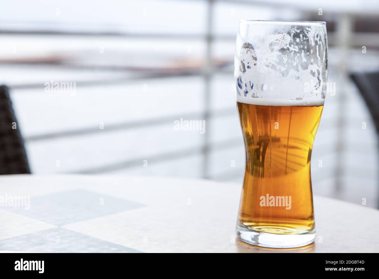 A transparent glass of golden beer drank with foam on the walls, rest ...